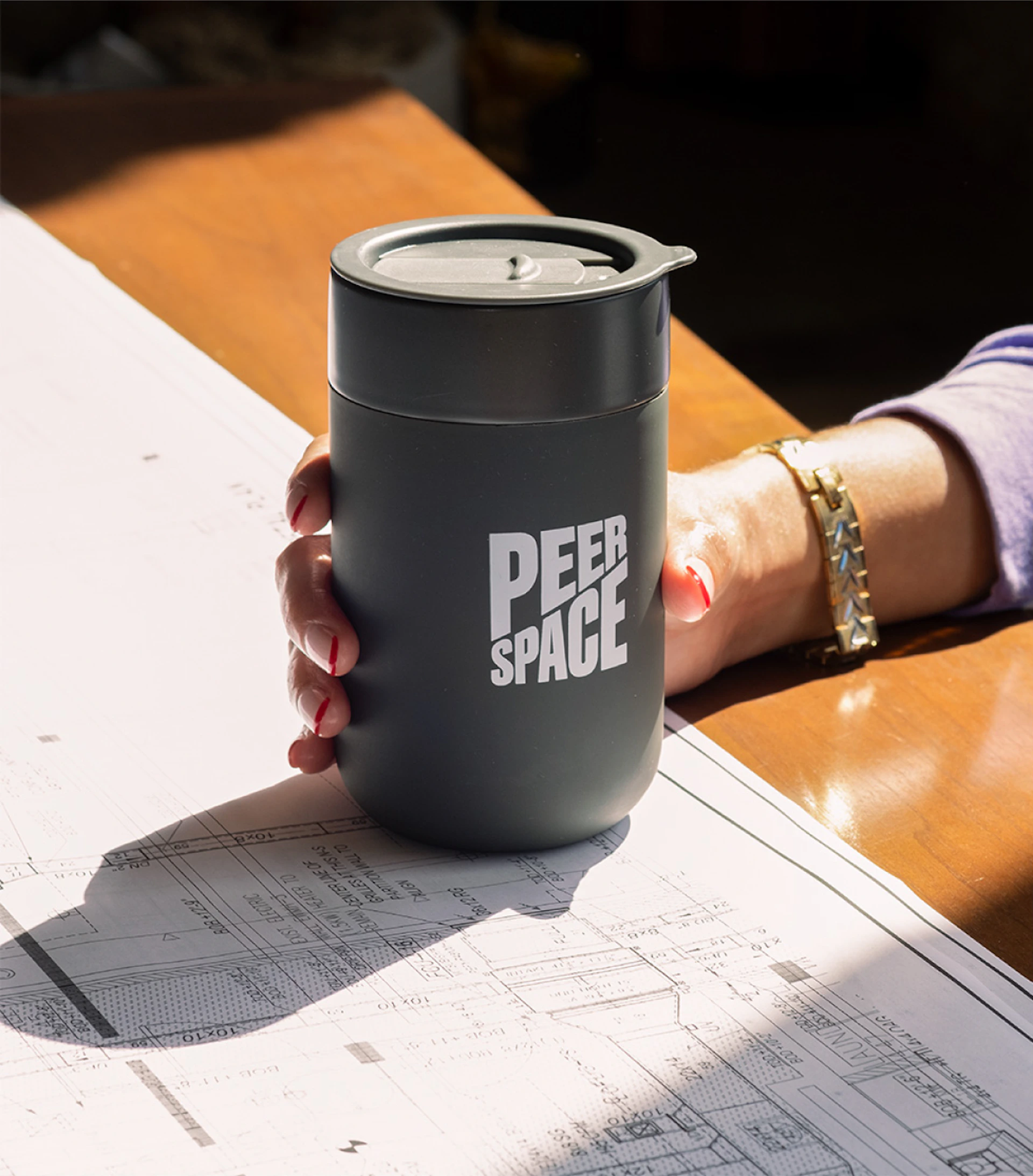 Branded water bottles by Peerspace for company merchandise